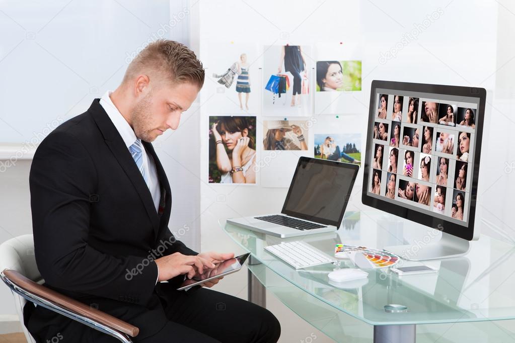 Businessman editing photographs — Stock Photo © AndreyPopov #44069747