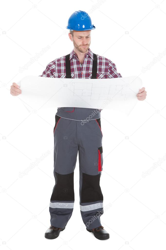 Male worker reading blueprint — Stock Photo © AndreyPopov #51170679