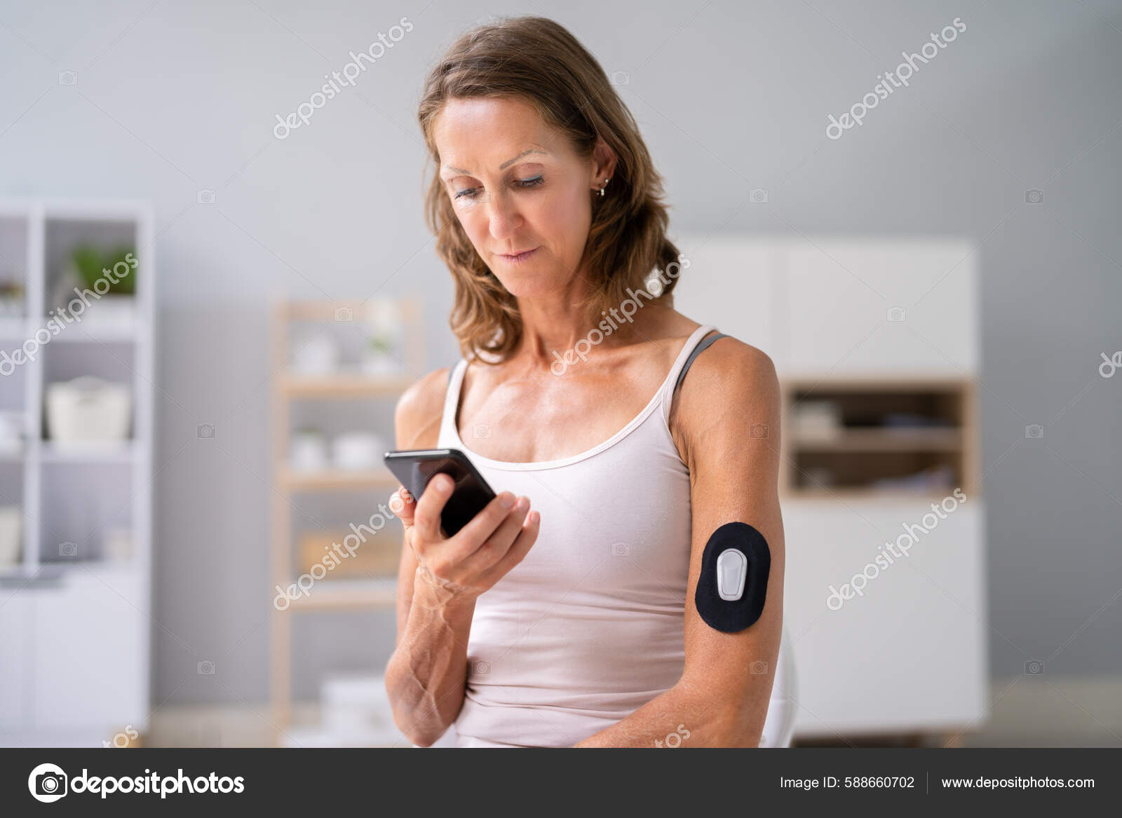 Woman Using Continuous Glucose Remote Monitor Diabetes Sensor Stock ...