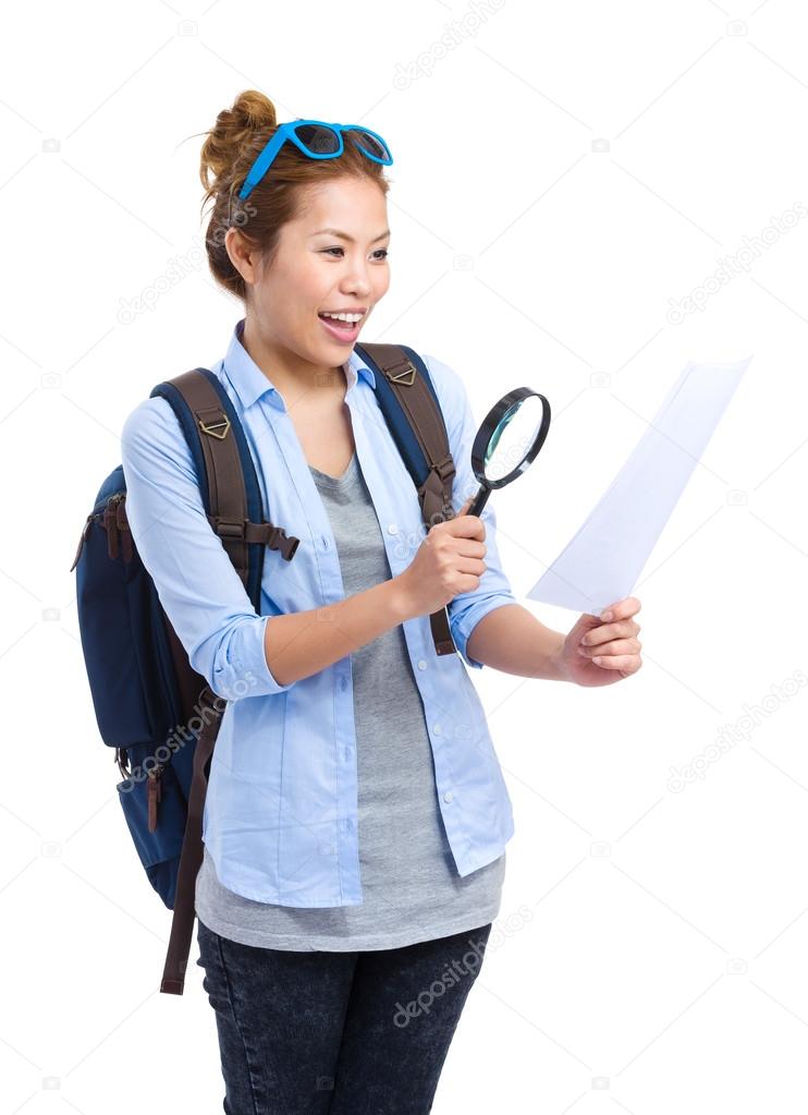 Woman looking at guide with magnify glass — Stock Photo © leungchopan ...