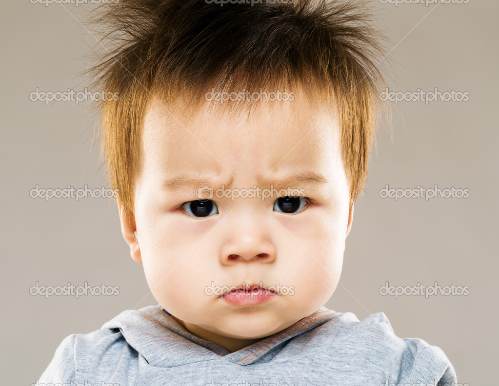 Serious asia baby boy eyebrow frown Stock Photo by ©leungchopan 46851447