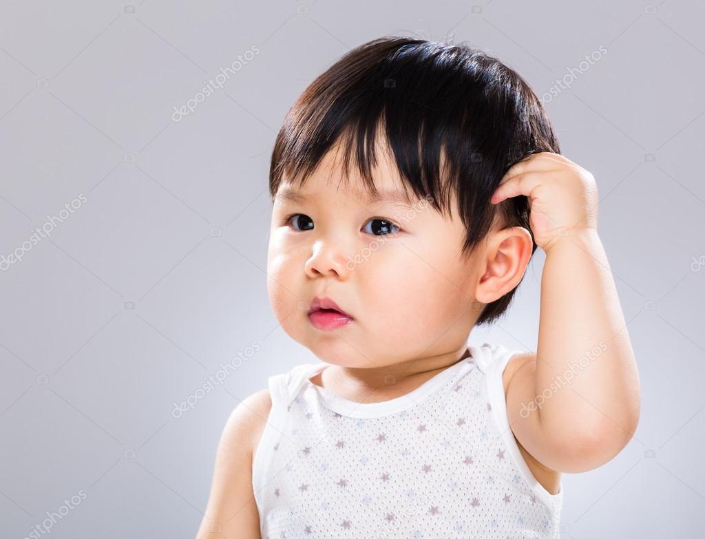 Baby boy scratch head Stock Photo by ©leungchopan 47444457
