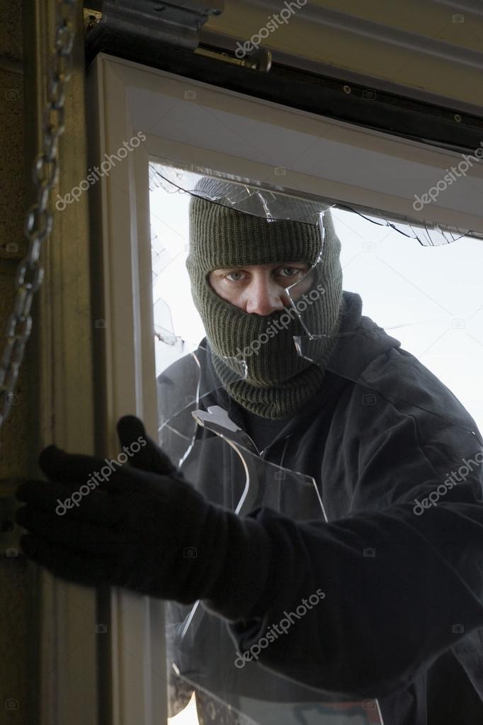Masked Thief Breaking In Through Window — Stock Photo © londondeposit ...