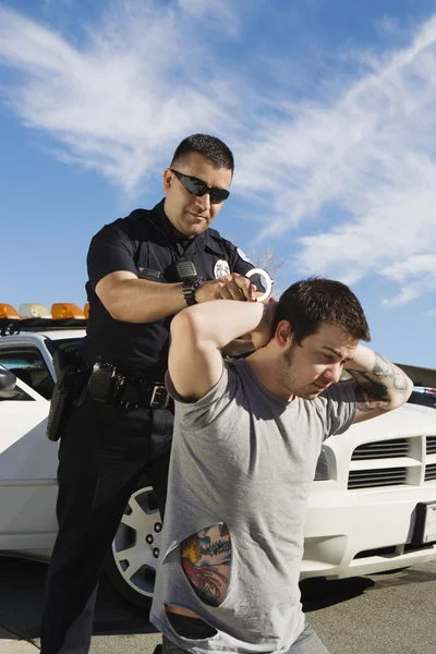 Officer Arresting Young Man — Stock Photo © londondeposit #21800411
