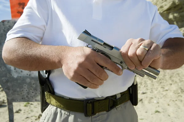 Man Loading Hand Gun At Firing Range — Stock Photo © londondeposit ...