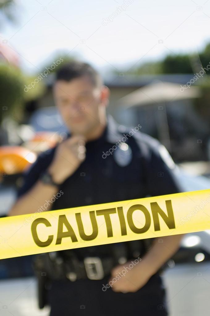 Police Officer Standing Behind Caution Tape Stock Photo by ...
