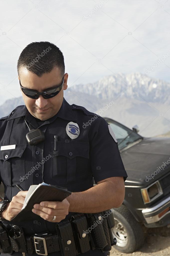 Police Officer Taking Notes — Stock Photo © londondeposit #21801351