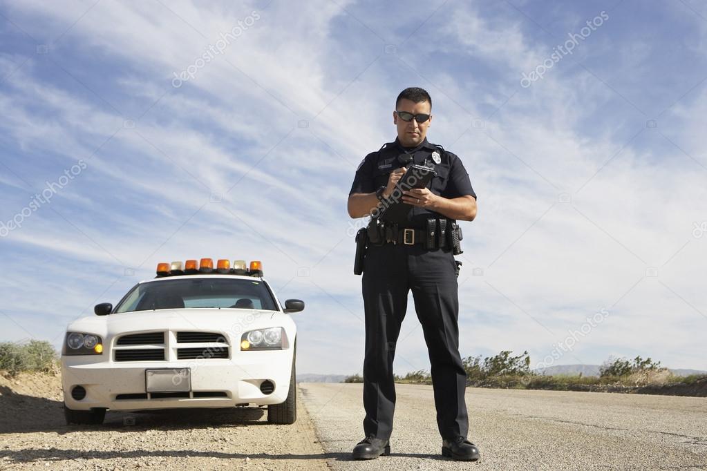 Police Officer Taking Notes In Front Of Car — Stock Photo ...
