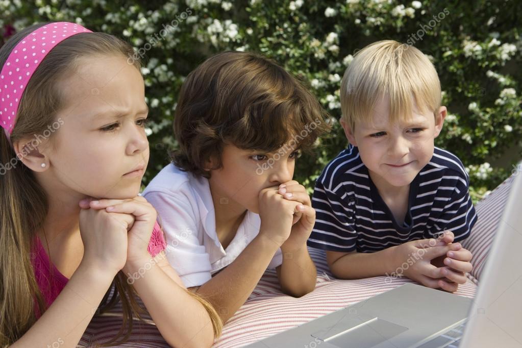 Concerned kids with laptop — Stock Photo © londondeposit #21830269