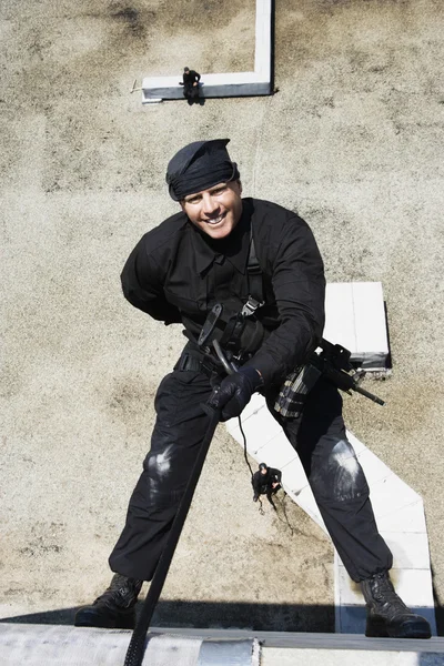 SWAT Team Officer Rappelling and Aiming Gun Stock Photo by ...
