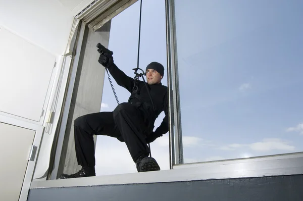 SWAT Team Officer Rappelling and Aiming Gun Stock Photo by ...