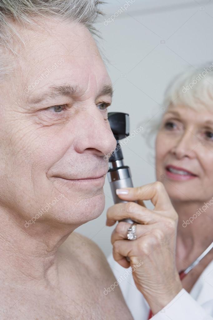 Doctor Examining Patient's Ear Using Otoscope Stock Photo by ...