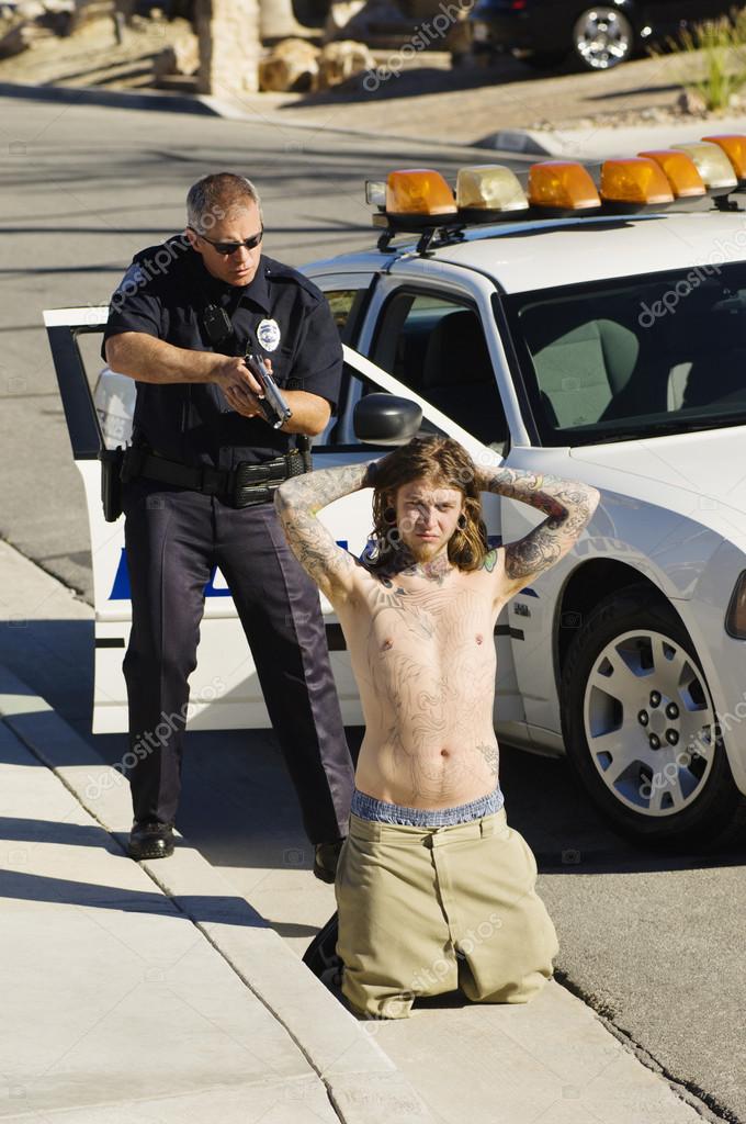 Police Officer Arresting Young Man ⬇ Stock Photo, Image by ...