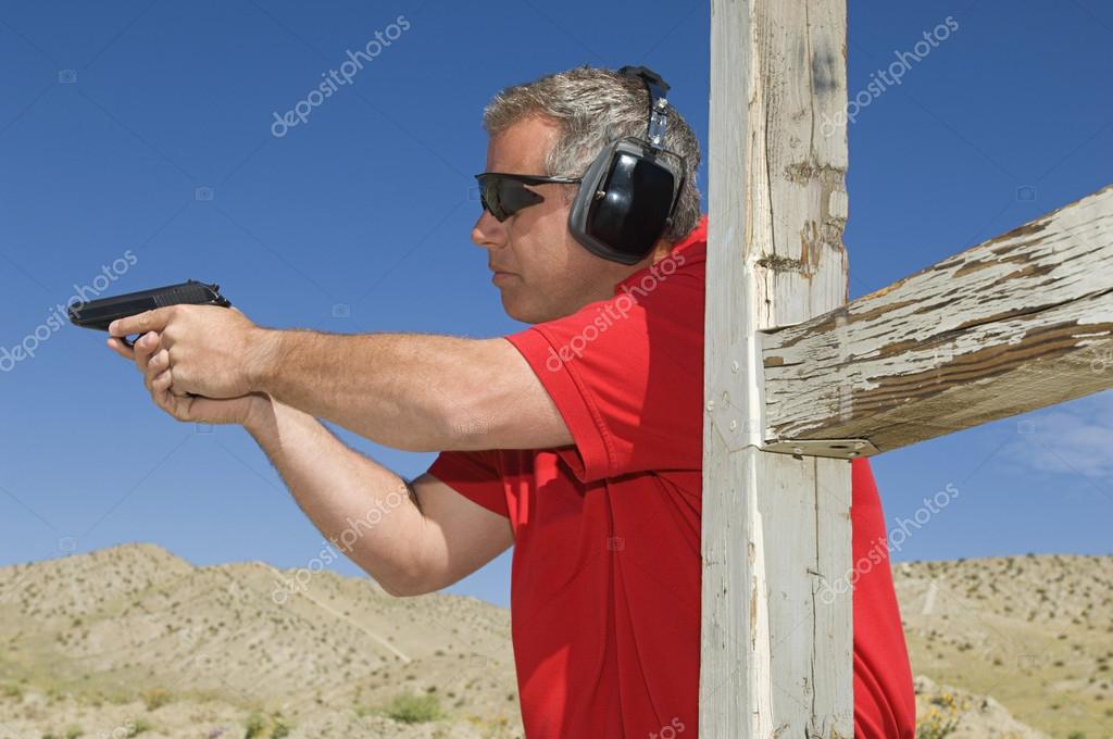 Man Pointing Gun To The Side