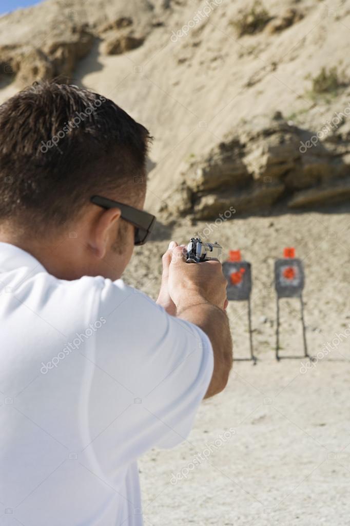 Man Aiming Hand Gun At Firing Range Stock Photo by ©londondeposit 21959277