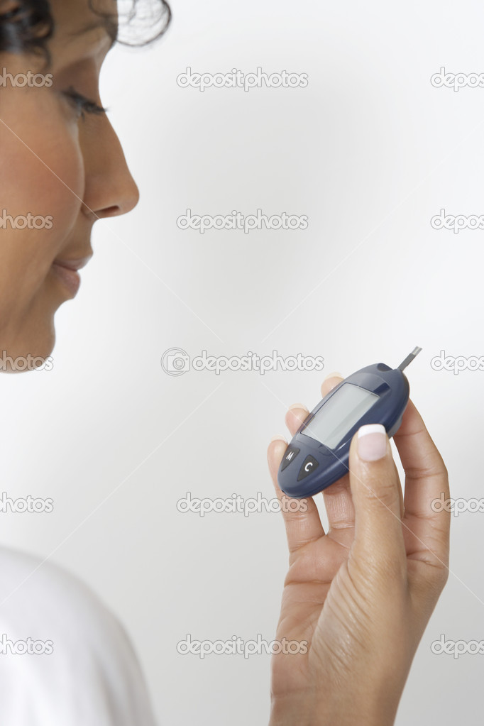 Woman Checking Diabetes using Glucometer — Stock Photo © londondeposit ...