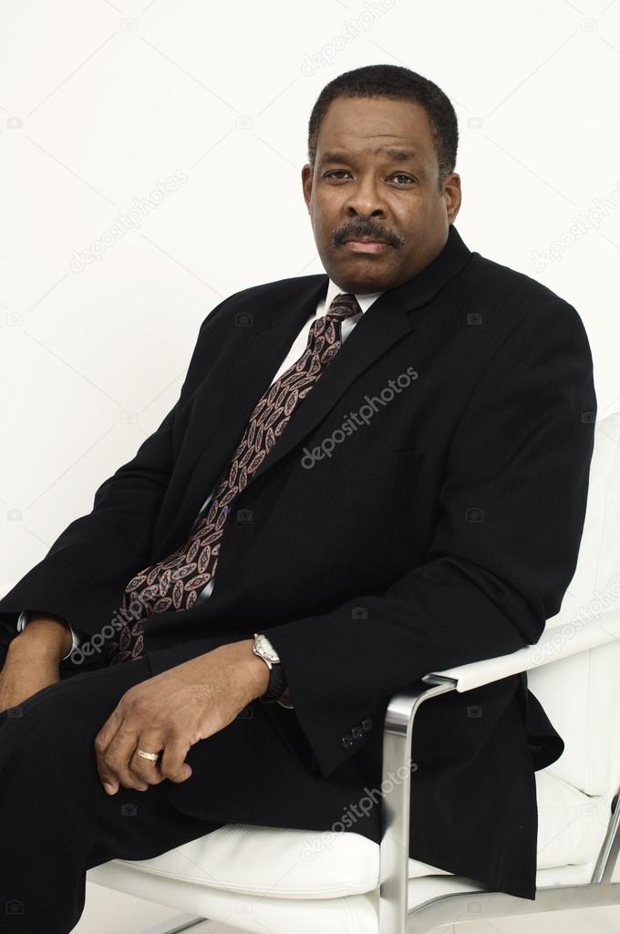 Confident Businessman Sitting On Chair Stock Photo by ©londondeposit ...
