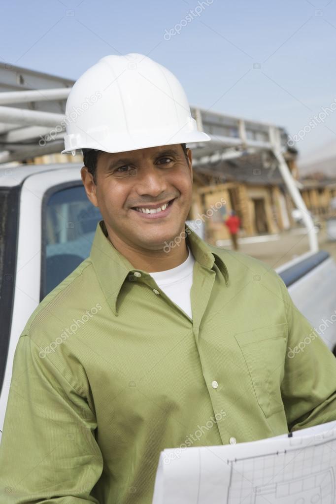 Construction worker with blueprints — Stock Photo © londondeposit #33795445