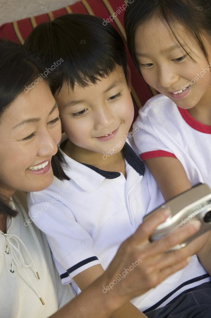 Mother and Children Looking pictures — Stock Photo © londondeposit #33807135