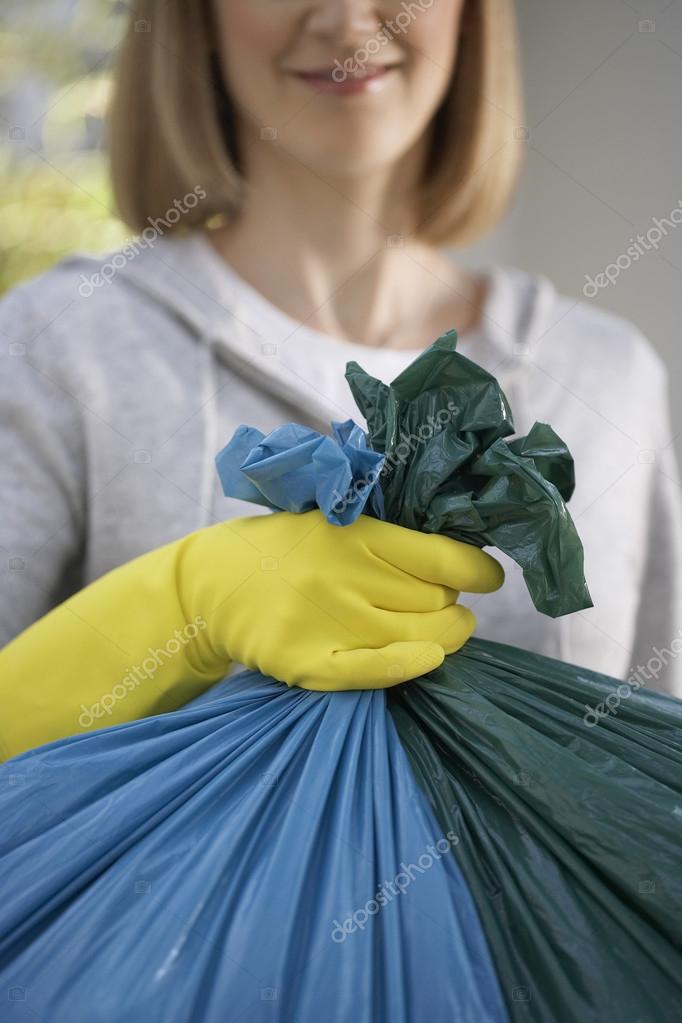 Woman holding garbage bag — Stock Photo © londondeposit #33821425