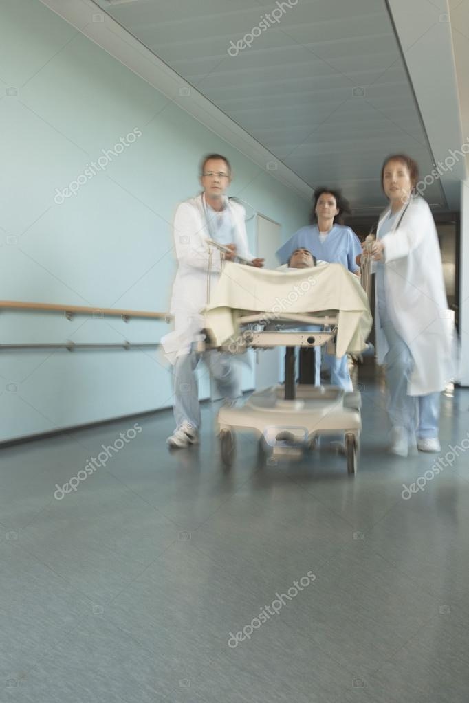 Physicians Rushing Patient on gurney Stock Photo by ©londondeposit 33823051