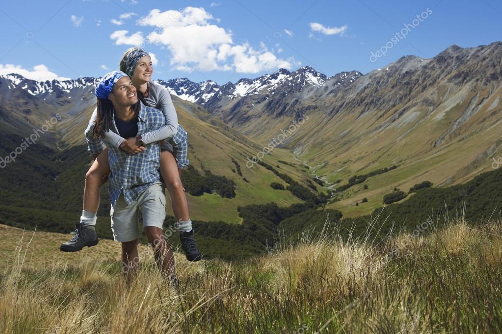 Man giving woman piggy-back ride — Stock Photo © londondeposit #33827641