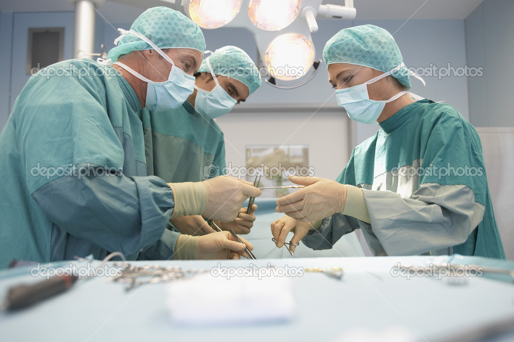 Three surgeons at work — Stock Photo © londondeposit #33829467