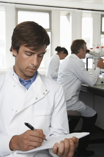 Lab Worker Examining Test Tube Stock Photo by ©londondeposit 33827729