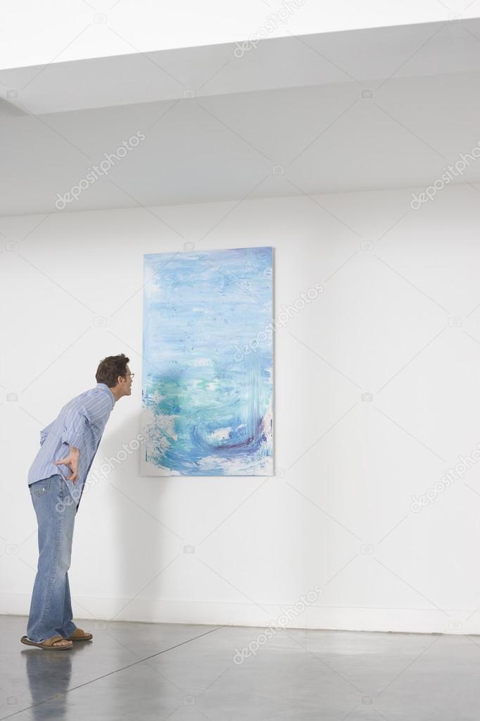 Man observing painting Stock Photo by ©londondeposit 33832259