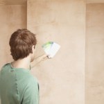 Man looking at paint colour swatches Stock Photo by ©londondeposit 33847611