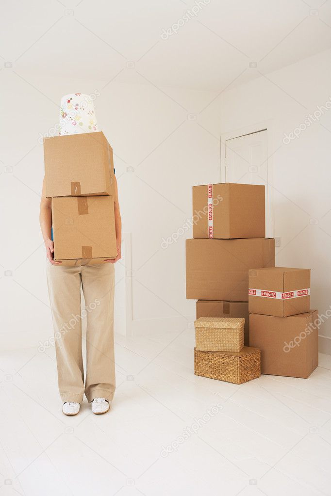 Person carrying moving boxes — Stock Photo © londondeposit #33841923