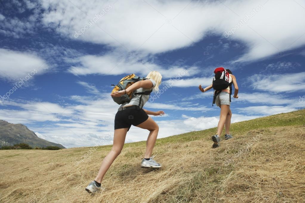 Two women running up hill — Stock Photo © londondeposit #33842353
