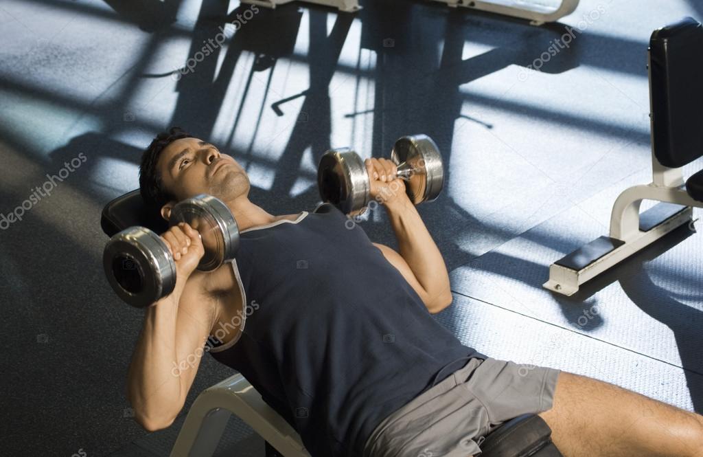 Man Using Dumbbells — Stock Photo © londondeposit #33844205
