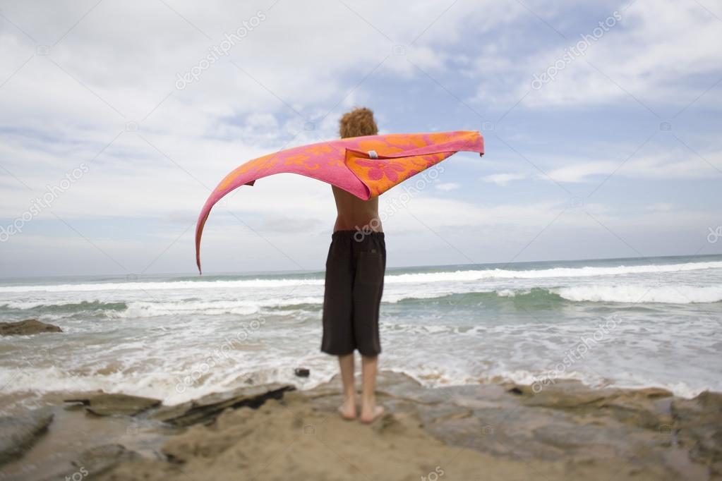 Boy on beach with open arms — Stock Photo © londondeposit #33844687