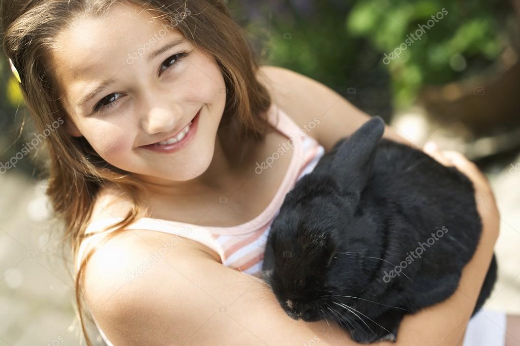 Girl holding bunny rabbit Stock Photo by ©londondeposit 33845887