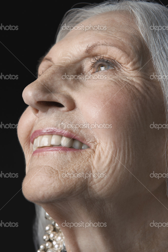 Senior Woman looking up — Stock Photo © londondeposit #33853037