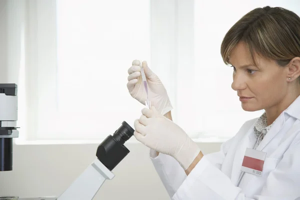 Female Technician Using Microscope Stock Photo by ©londondeposit 33861227