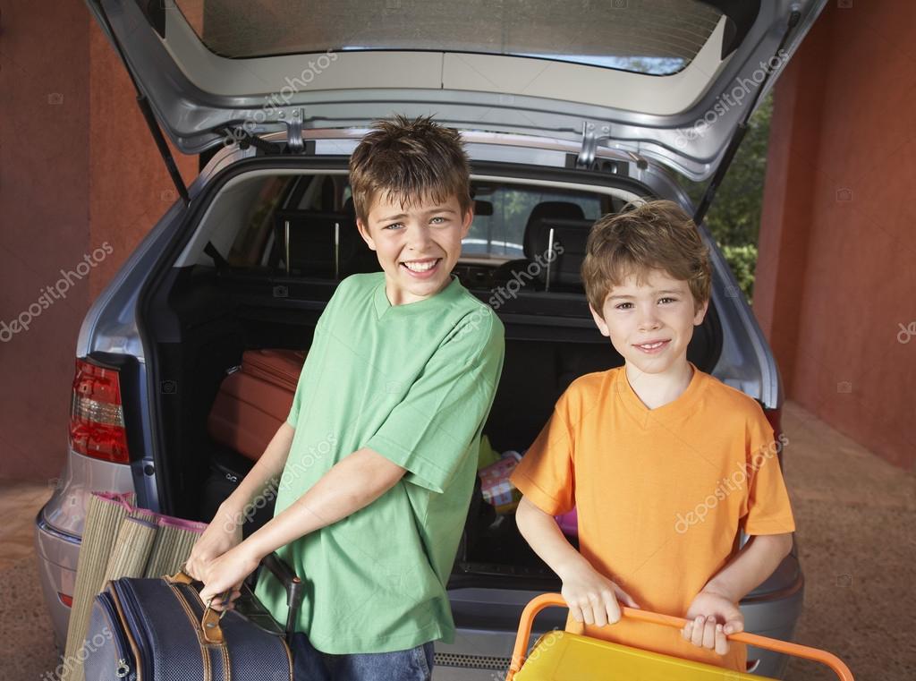 Boys carrying suitcases — Stock Photo © londondeposit #33876679
