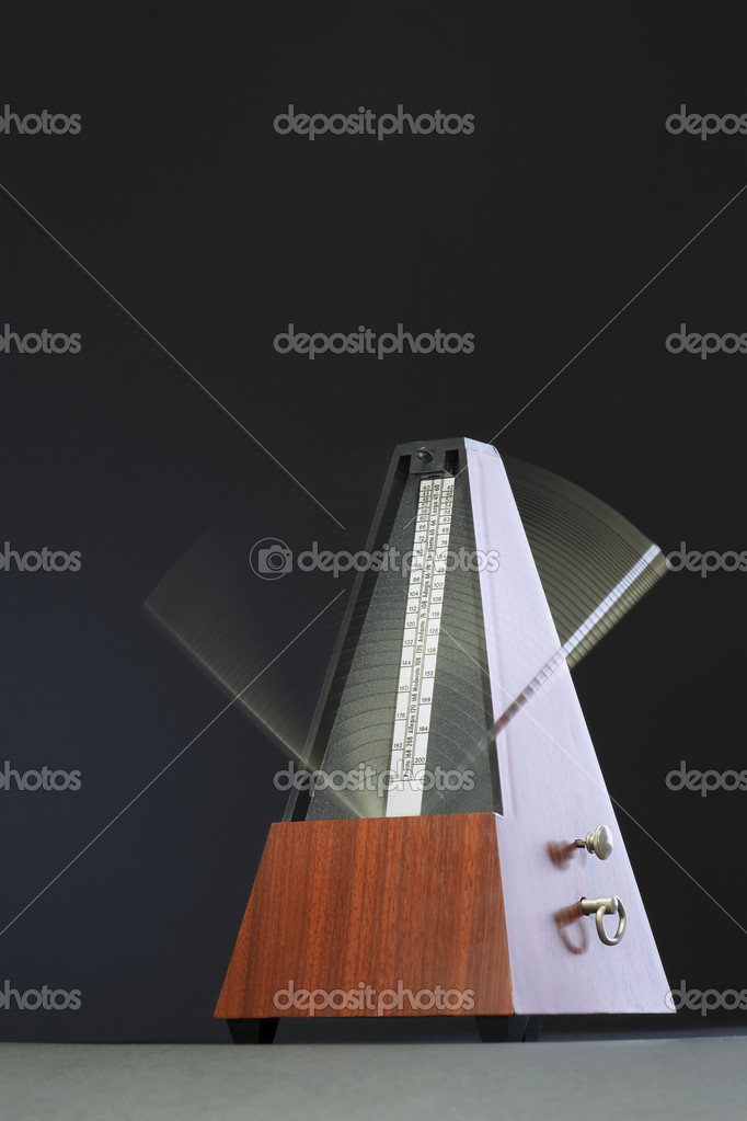 Metronome in motion Stock Photo by ©londondeposit 33883277
