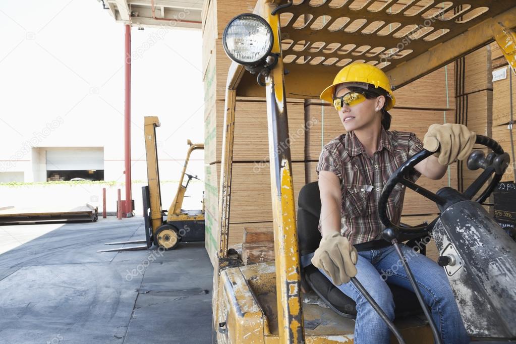 Female industrial worker driving — Stock Photo © londondeposit #33982315
