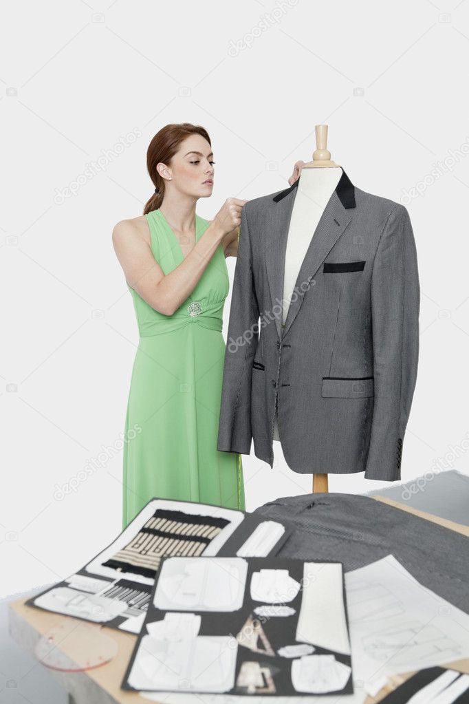 Female designer adjusting coat Stock Photo by ©londondeposit 33987987
