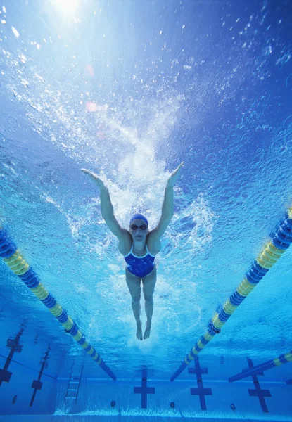 Professional female swimmer in pool Stock Photo by ©londondeposit 33993965