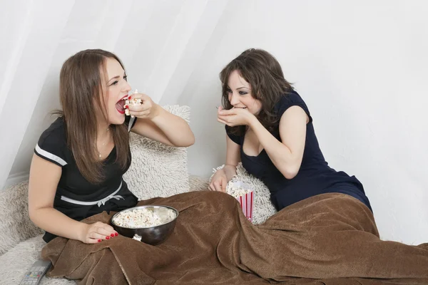 Friends drinking soda and eating popcorn — Stock Photo © tonodiaz #51467353