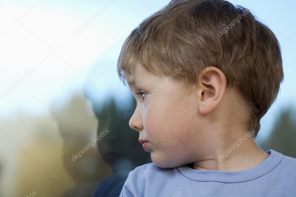 Young boy looking back at shadow in glass — Stock Photo © londondeposit ...
