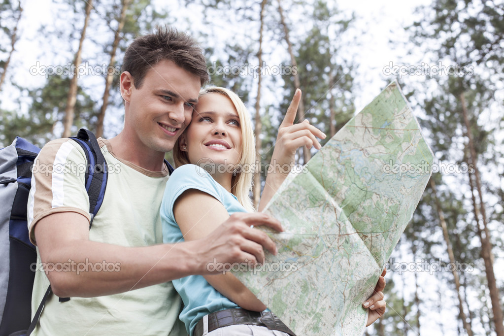 Couple holding map Stock Photo by ©londondeposit 33997411