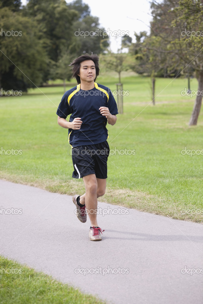 Chinese man jogging at park Stock Photo by ©londondeposit 34000569