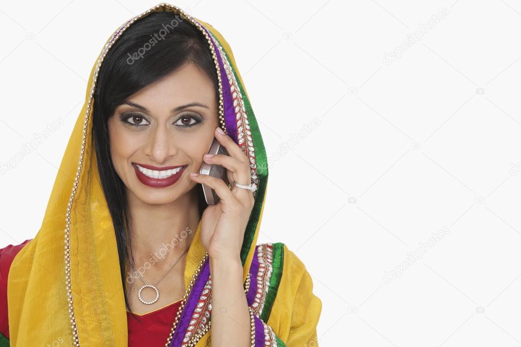 Indian woman answering phone call Stock Photo by ©londondeposit 34002271