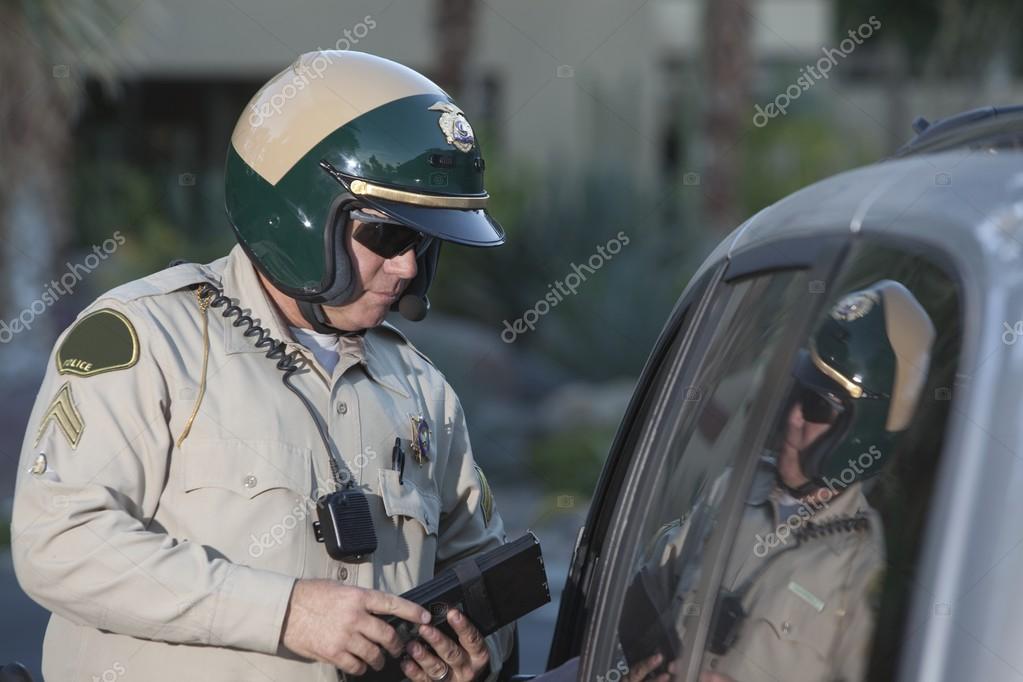 Patrol officer at window of car — Stock Photo © londondeposit #34011437