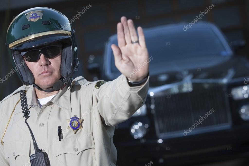 Officer stops traffic Stock Photo by ©londondeposit 34020951