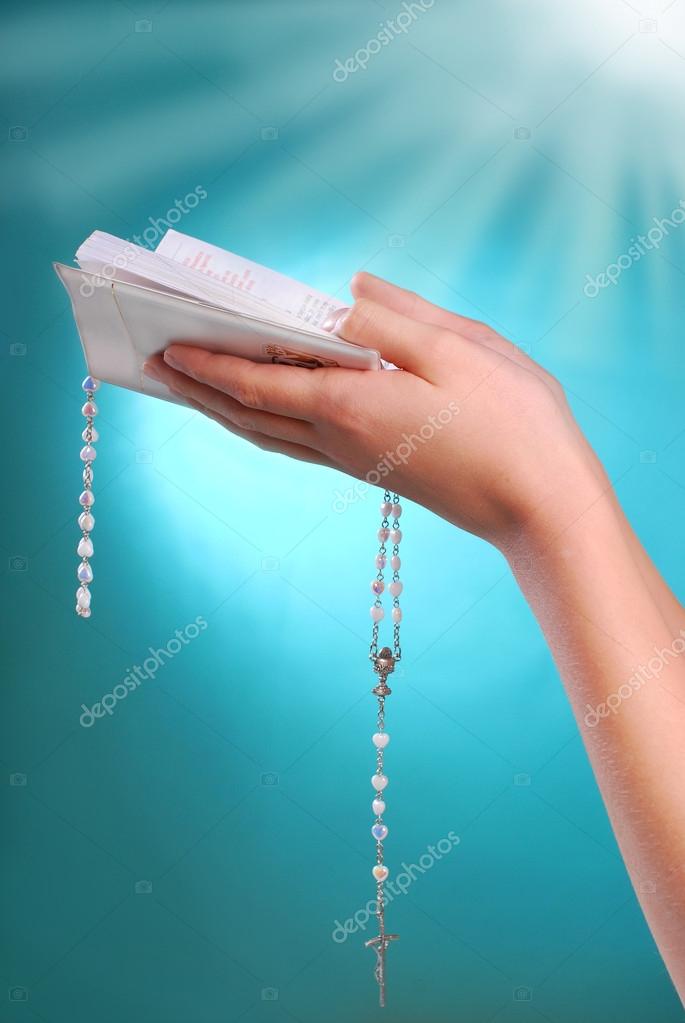 The first holy communion with prayer book in hands Stock Photo by ...